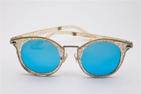 Closeup To Glitter Frame With Blue Lens Sunglasses Isolated Stock
