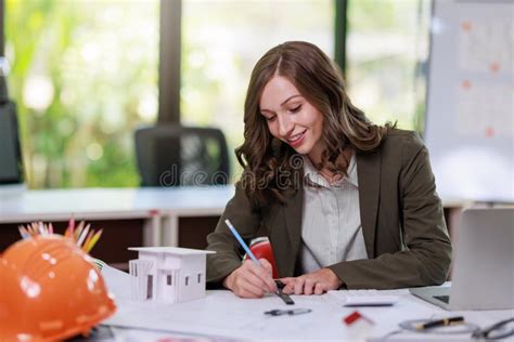 Construction Concept Of Engineer And Architect Working With Construction Model And Blueprint