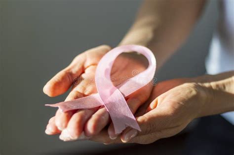 Shot Of A Woman Holding Pink Ribbon Symbol Of A Breast Cancer