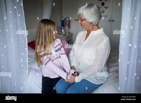 Smiling Grandmother And Granddaughter Interacting With Each Other On