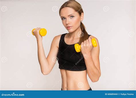 Sporty Girl Doing Exercise With Dumbbells And Looking At Camera Stock