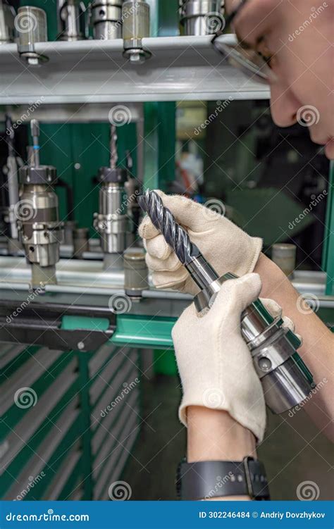 To Operate A Cnc Machine A Worker Selects And Inspects The Required