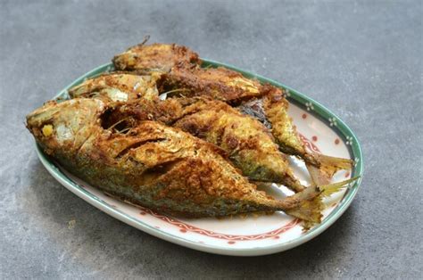 Premium Photo Close Up Of Fried Mackerel Fish In Plate On Table