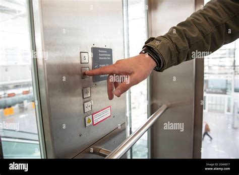 Man Pressing Button In Elevator Stock Photo Alamy