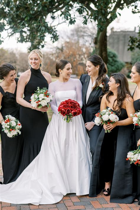 Bride In Dress With Illusion Neckline And Sleeves And Red Bouquet