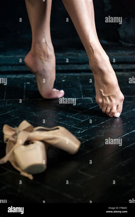 Close Up Ballerinas Legs And Pointes On The Black Wooden Floor Stock