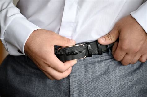 A Man Puts On A Belt On His Pants A Classic Of A Businessmanand X27 S