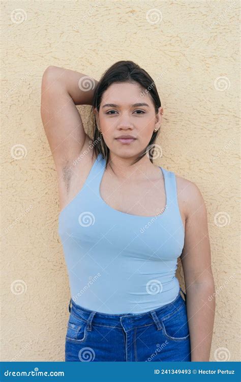 Hispanic Woman With Unshaven Armpits Confidently Looking At The Camera