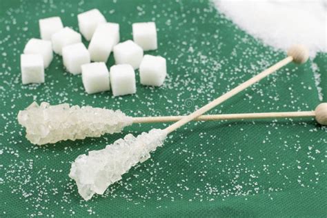 Two Sugar Sticks And Sugar Cubes On Green Stock Image Image Of