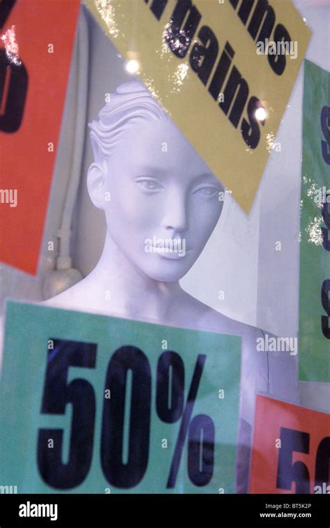 Female White Mannequin Head In Window Of Shop With Sale Signs Stock