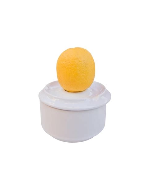 Premium Photo Close Up Of Lemon On Container Against White Background