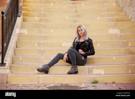 Beautiful Blonde Girl Wearing Tight Jeans And A Black T Shirt Outdoors