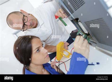 Girl With A Tester And A Printed Circuit Board Stock Photo Alamy