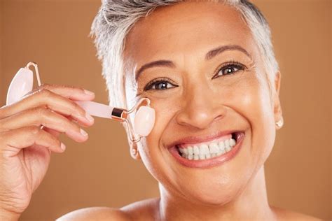 Premium Photo Portrait Of Senior Beauty Rose Quartz Roller And Woman