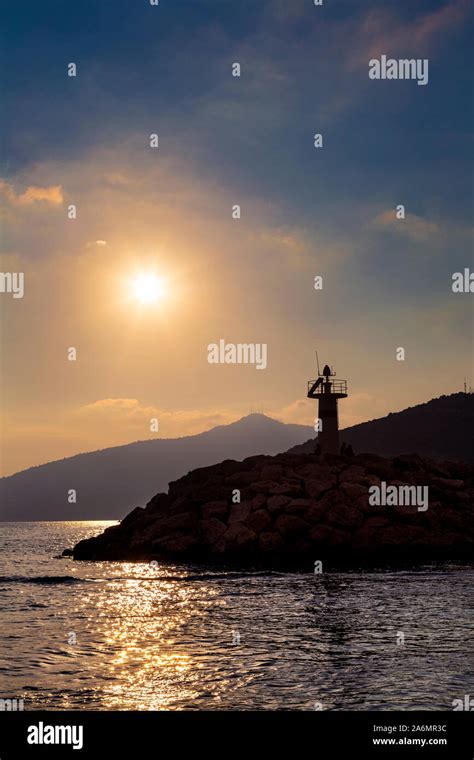 The Lighthouse At Sunset In The Harbour Town And Popular Tourist