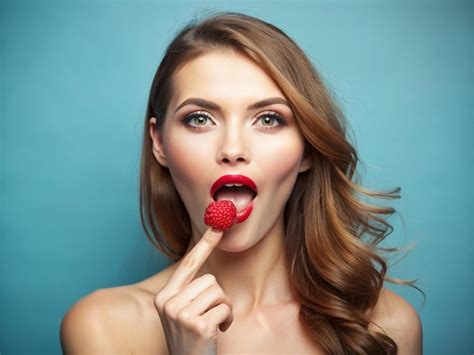 Premium Photo A Young Women Blowing A Raspberry With Her Tongue Out