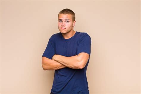 Premium Photo Blonde Man Shrugging Feeling Confused And Uncertain