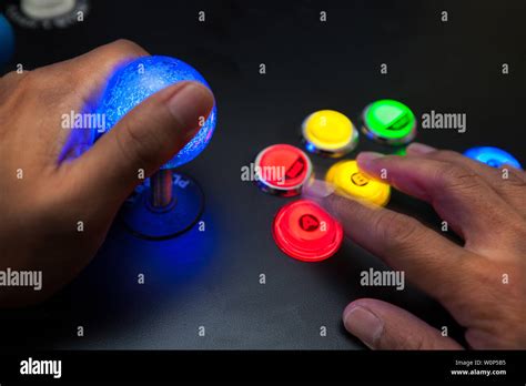Arcade Gamer Using A Lighted Joystick And Fighter Button Layout With Neo Geo Color Scheme Stock