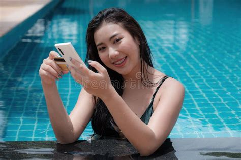 Young Pretty Woman Wear Bikini In Pool And Booking Flight Everywhere Can Online Shopping
