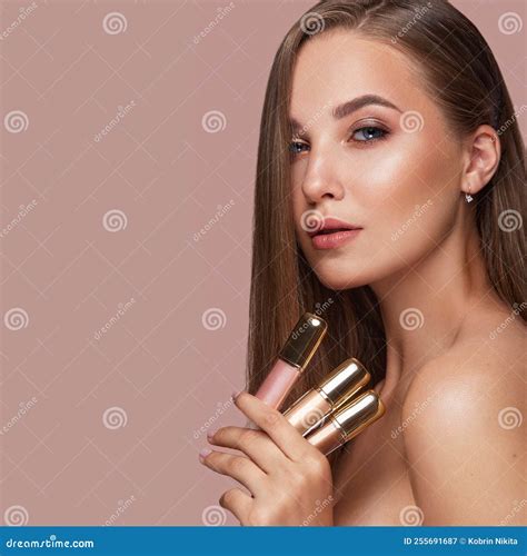 Beautiful Young Girl With Natural Nude Make Up With Cosmetic In Hands