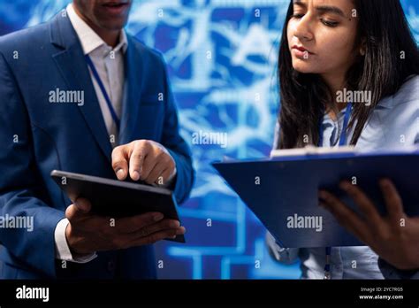 Developer And Colleague Analyzing Complex Ai Brain Models On Tablet It
