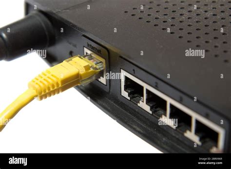 Wireless Router With Yellow Internet Cable On White Background Stock Photo Alamy