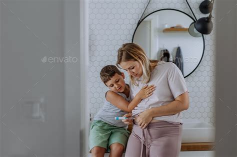 Woman Injecting Insulin In Her Belly While Her Son Watching And
