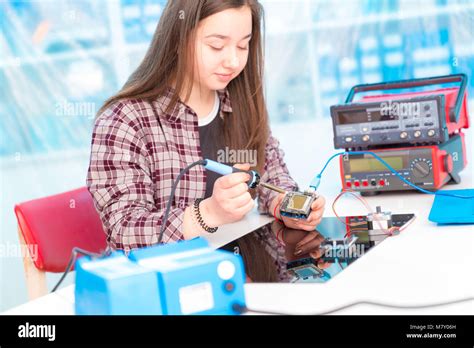 Schoolgirl In Laboratory Robots Debug Microcontroller Stock Photo Alamy