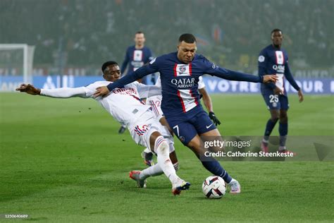 Sinaly Diomande Of Olympique Lyonnais Challenges Kylian Mbappe Of