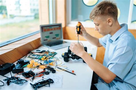 Student Fixing Robotics Vehicle Learn Technology In Stem Class
