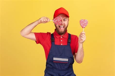 Premium Photo Worker Man In Blue Uniform Holding Tasty Sugary Candy