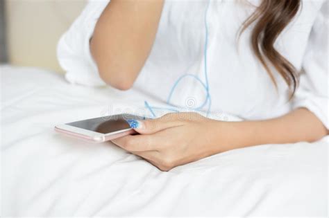 Asian Woman Smile Feel Carefree And She Lying On The Bed In The Stock