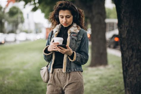 Free Photo Young Woman With Listening Music And Drinking Coffee