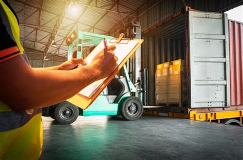Premium Photo Workers Checking The Loading Cargo Shipment At Warehouse Dock Forklift Loading