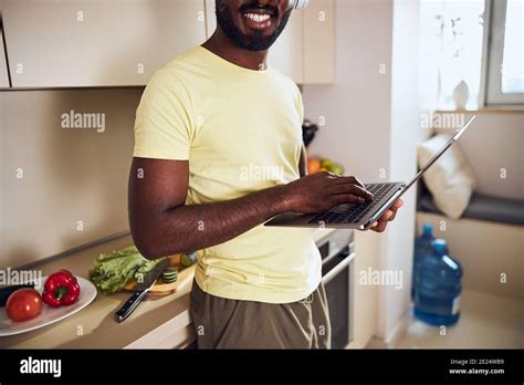 Adult Man Pressing Keys On The Laptop Near A Cooking Table Stock Photo Alamy