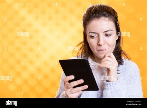 woman reading captivating ebook on ereader device enjoying hobby