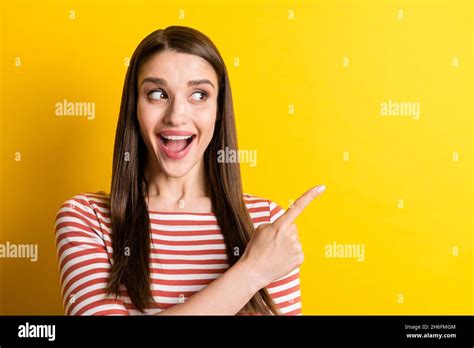Portrait Of Attractive Amazed Cheerful Girl Demonstrating Copy Space