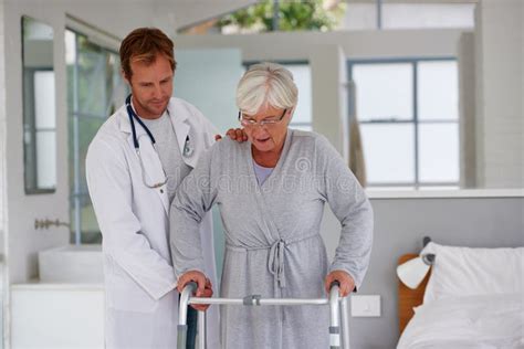 Patient Recovery Comes First A Senior Woman Walking Carefully With
