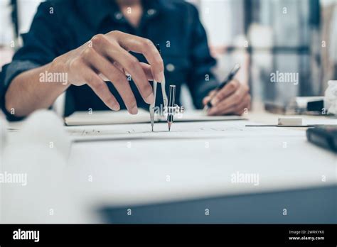 Architect Using Divider Compass Working On Blueprint And Make A Note On