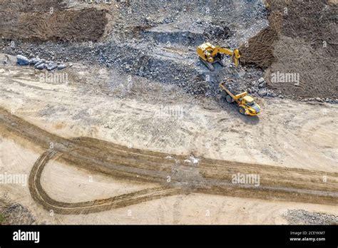 Drone Photo Excavator Loads Heavy Stones And Debris On Industrial