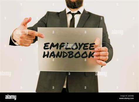 Sign Displaying Employee Handbookdocument That Contains An Operating Procedures Of Company