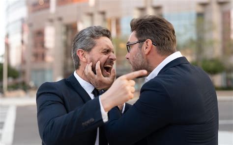 Premium Photo Two Businessmen Have Business Conflict And Blaming Each