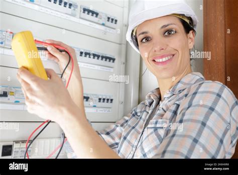 Woman Using Voltage On Fuseboard Stock Photo Alamy