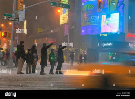 Hailing A Cab During Winter Storm In Times Square New York City New York United States Of
