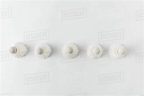 Top View Of Badminton Shuttlecocks In Row On White Surface Stock