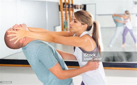 Girl Attacking Eyes Of Male Partner During Selfdefense Workout Stock