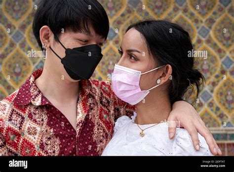 Man Embracing His Transgender Couple Outside A Buddhist Temple Stock