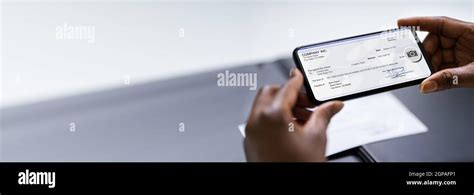 Remote Check Deposit Taking Photo With Mobile Phone Stock Photo Alamy