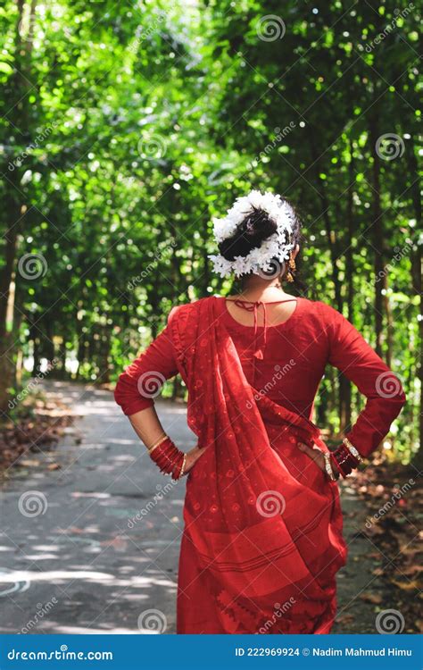 Young Woman Wearing A Red Saree Walking On Green Asphalt Road The Girl