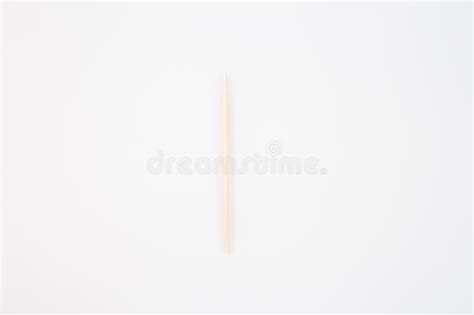 A Single Toothpick Placed On White Background Toothpick The Central
